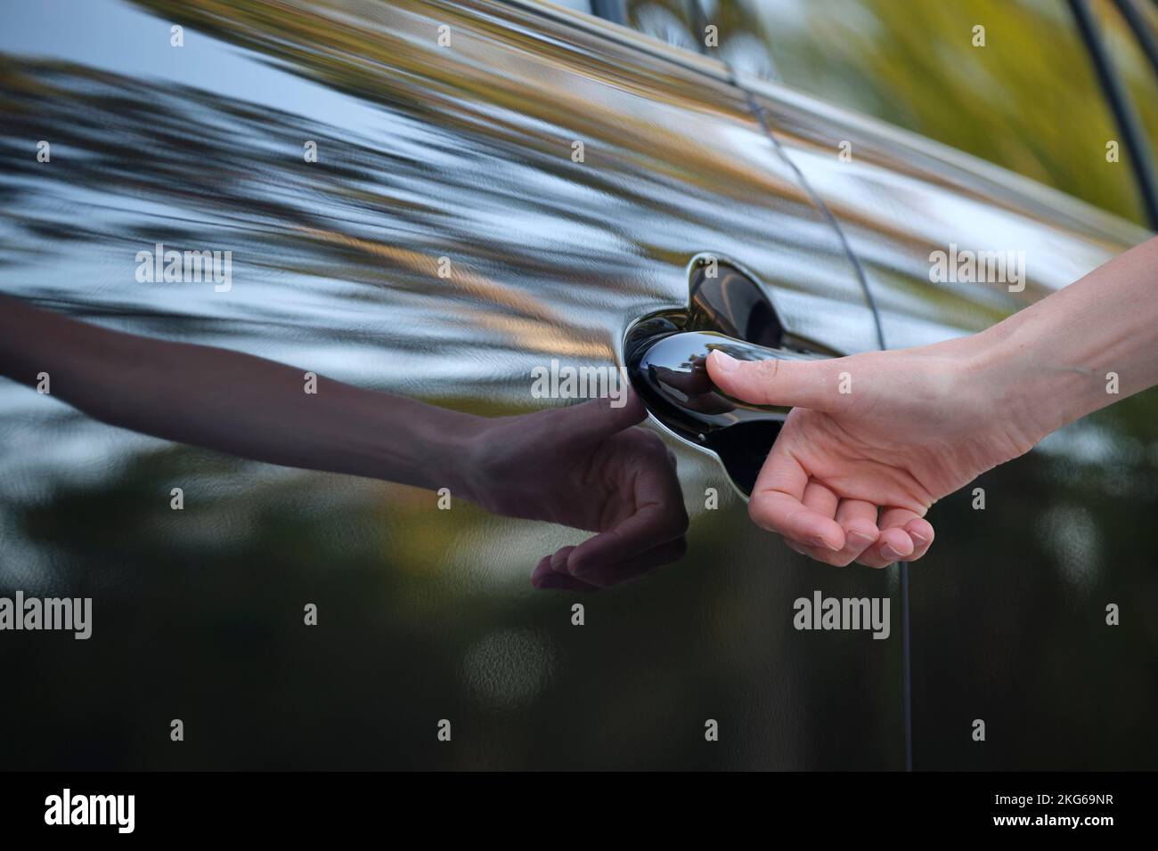 Closeup of driver hand opening car front door with touch ID finger ...
