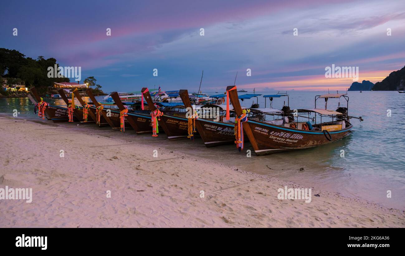 Longtail boats during sunset on the Beach of Koh Phi Phi Don Thailand ...
