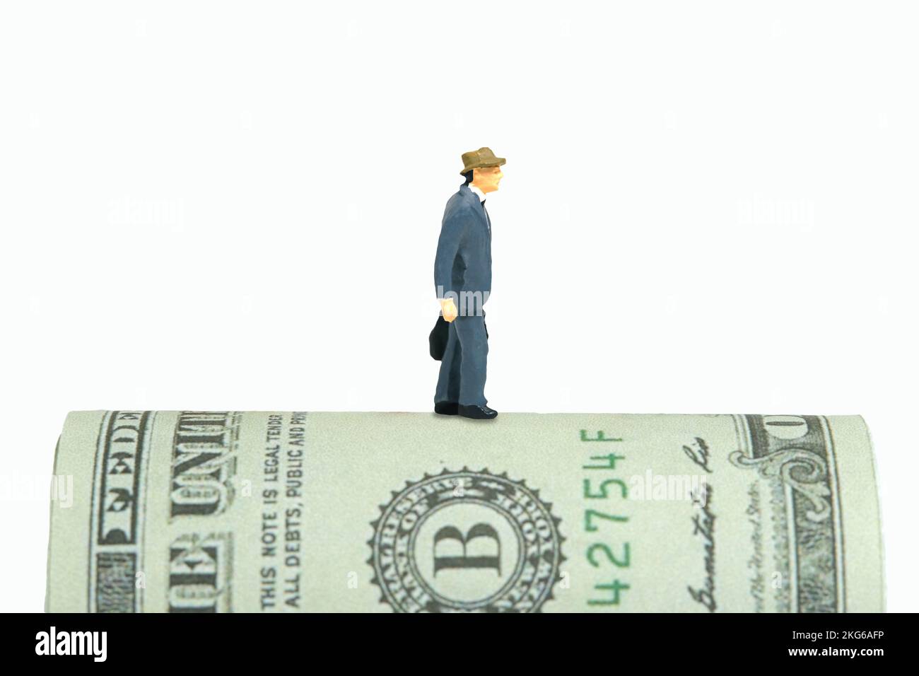 Miniature people toy figure photography. A businessman walking above ...