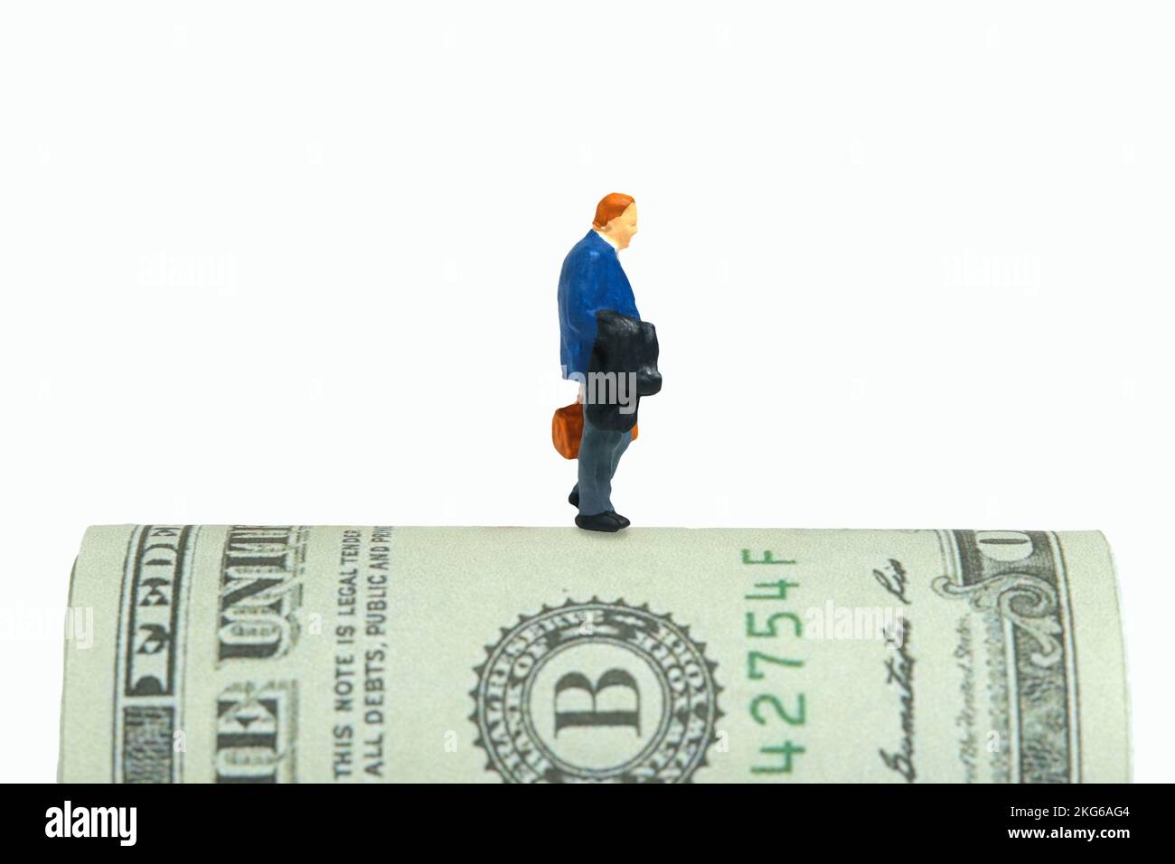 Miniature people toy figure photography. A businessman walking above ...