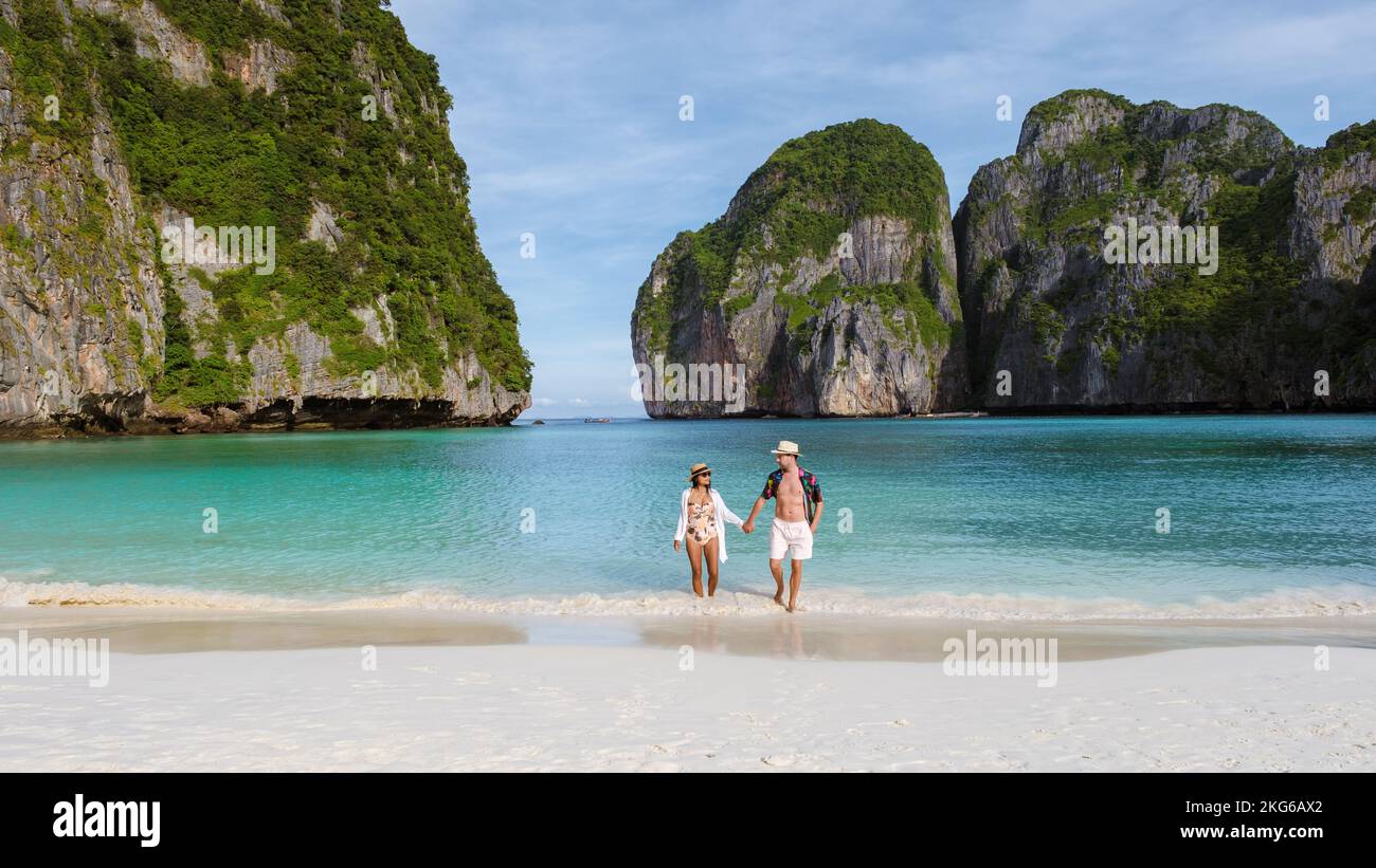Thai women in bad suits and caucasian men in swim short walks on the ...