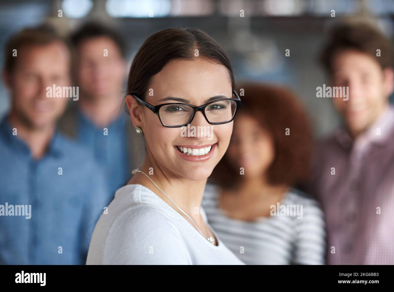 I have a strong team to back me up. Smiling young woman looking at the ...