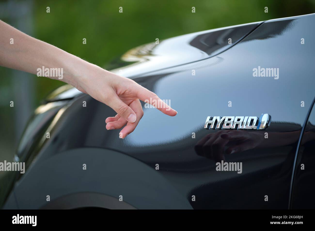 Human hand showing hybrid car sign on new effective vehicle Stock Photo ...