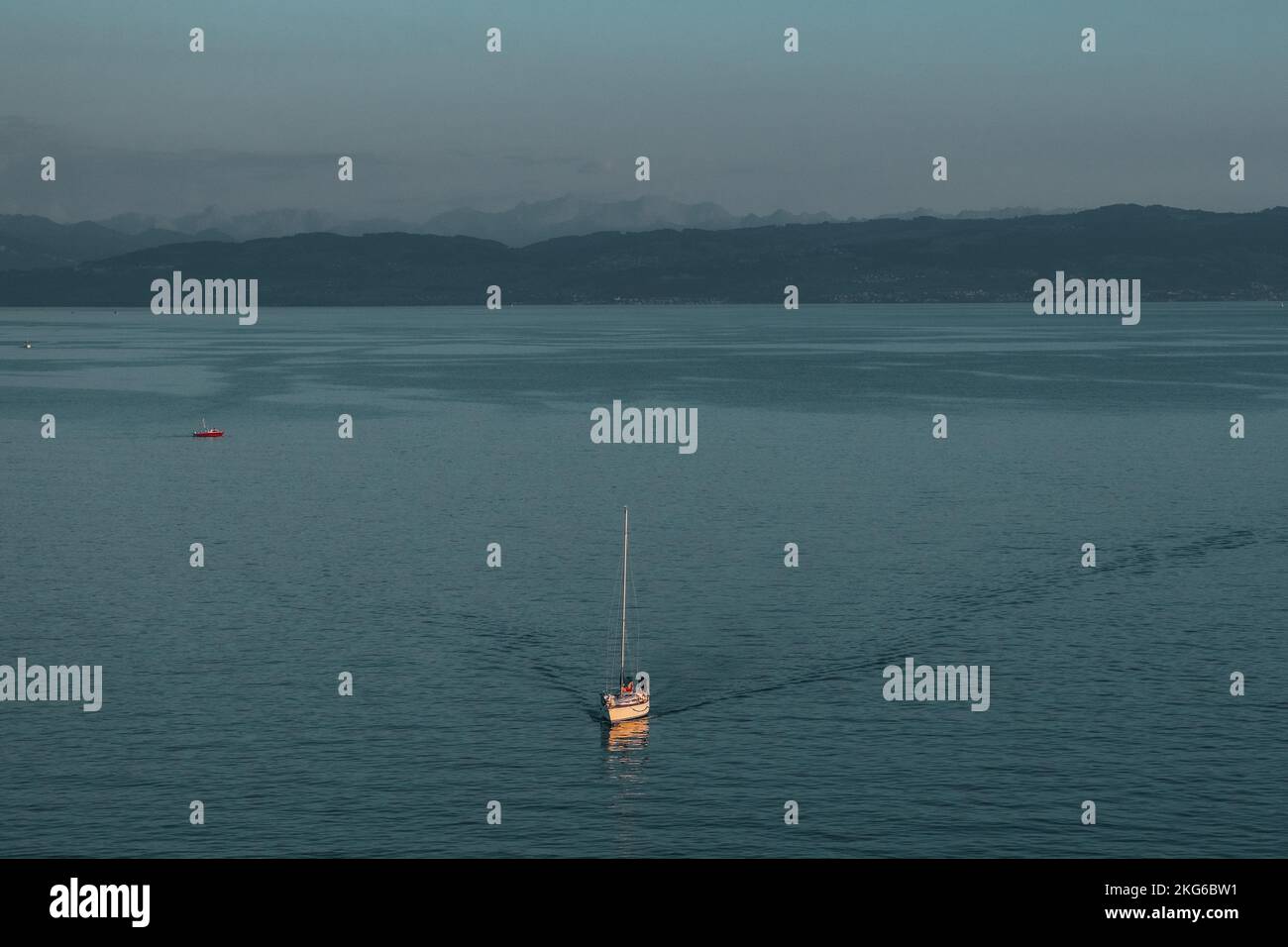 An aerial view of boat floating in sea during sunset Stock Photo - Alamy