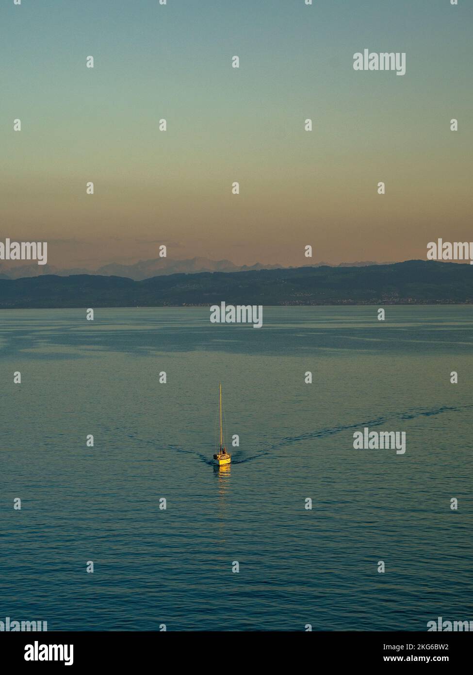 An aerial view of boat floating in sea during sunset Stock Photo - Alamy