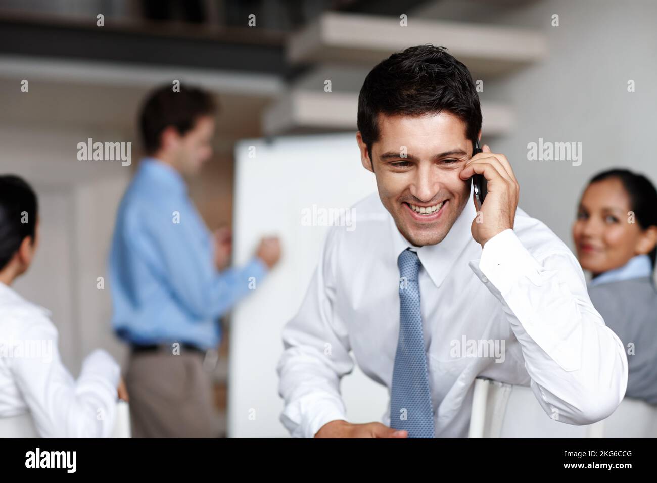 Taking an important client call. A young executive taking a call during ...