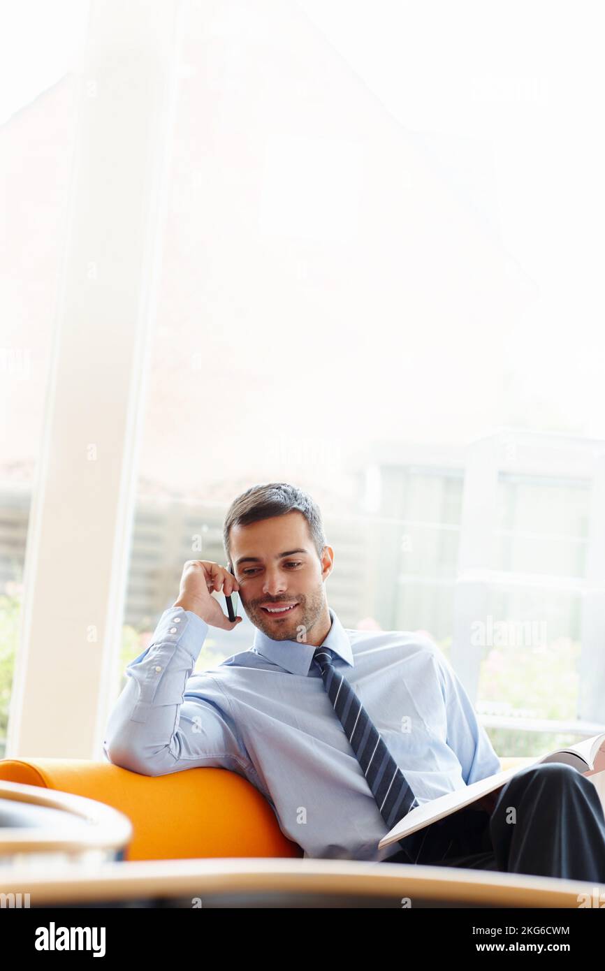 Successful businessman reading magazine hi-res stock photography and ...