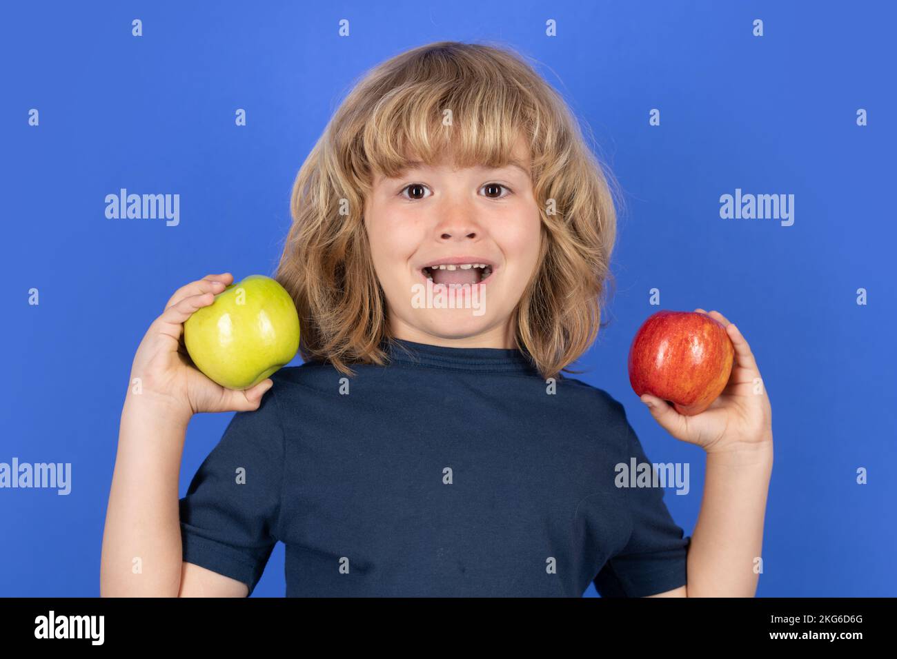 Excited child hold apple on isolated background Stock Photo - Alamy