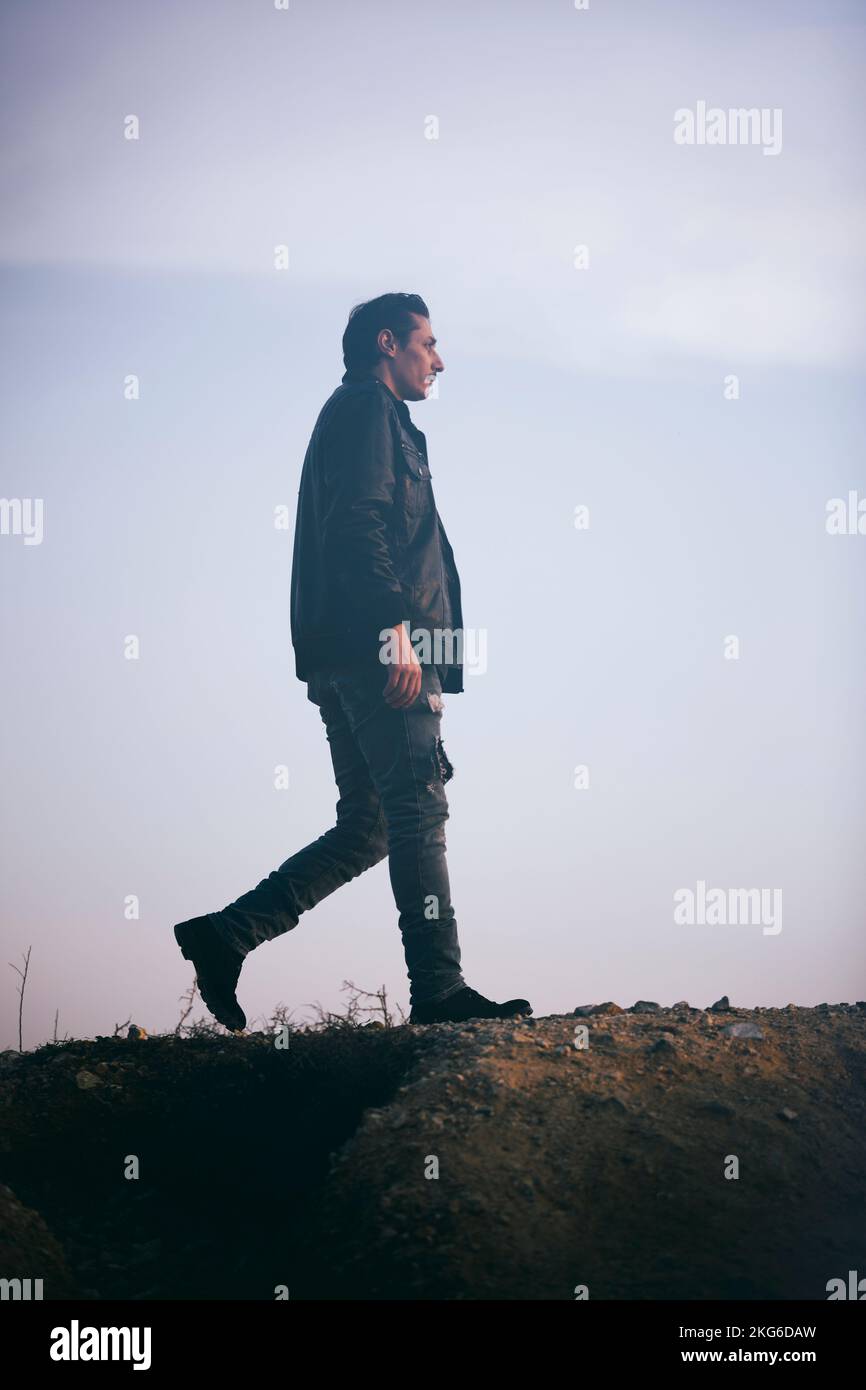 Side view full length man walking outdoors Stock Photo - Alamy