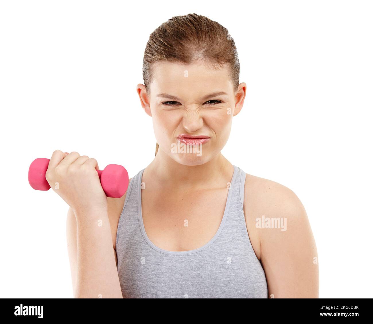 I want to build some muscles. A pretty teenage girl making a face while ...