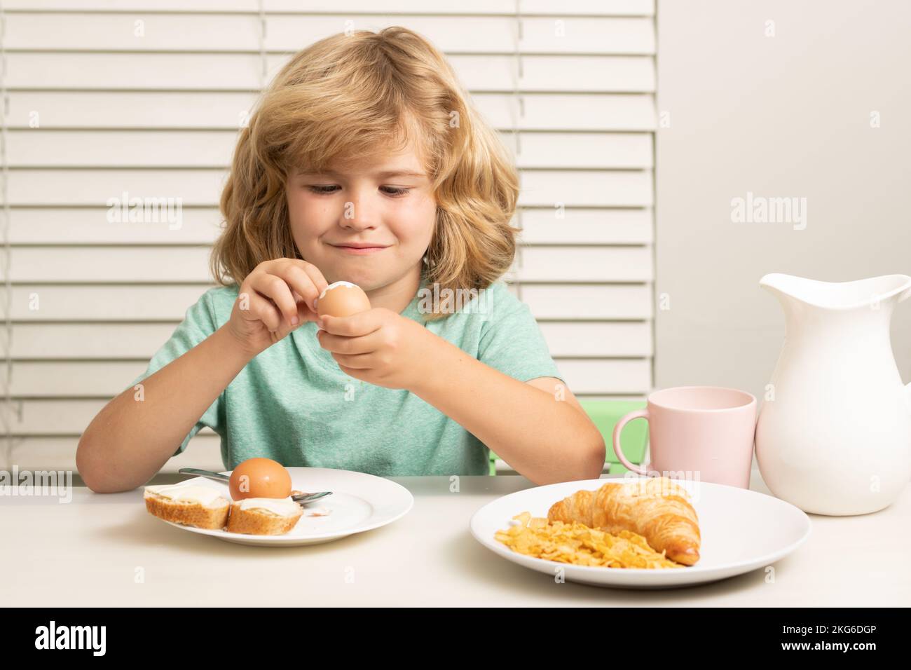 Child eating egg. Healthy nutrition for children. Cute boy enjoy eating ...