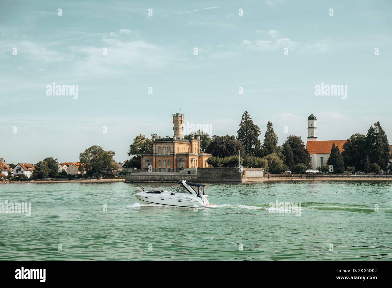 A boat floating in front of buildings in Lindau Stock Photo - Alamy