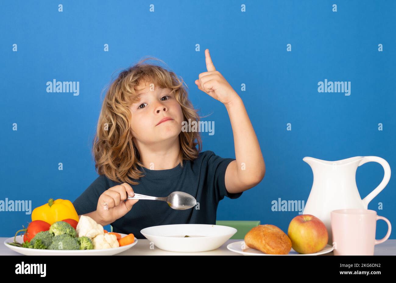 Funny child eating soup. Small kid eating a soup. Boy eating soup for ...