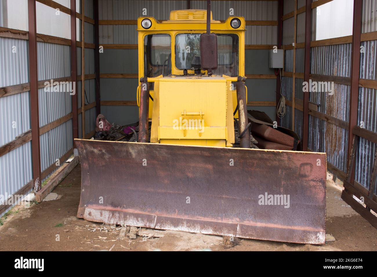 Large wheeled tractor with a dozer blade for clearing roads from snow ...