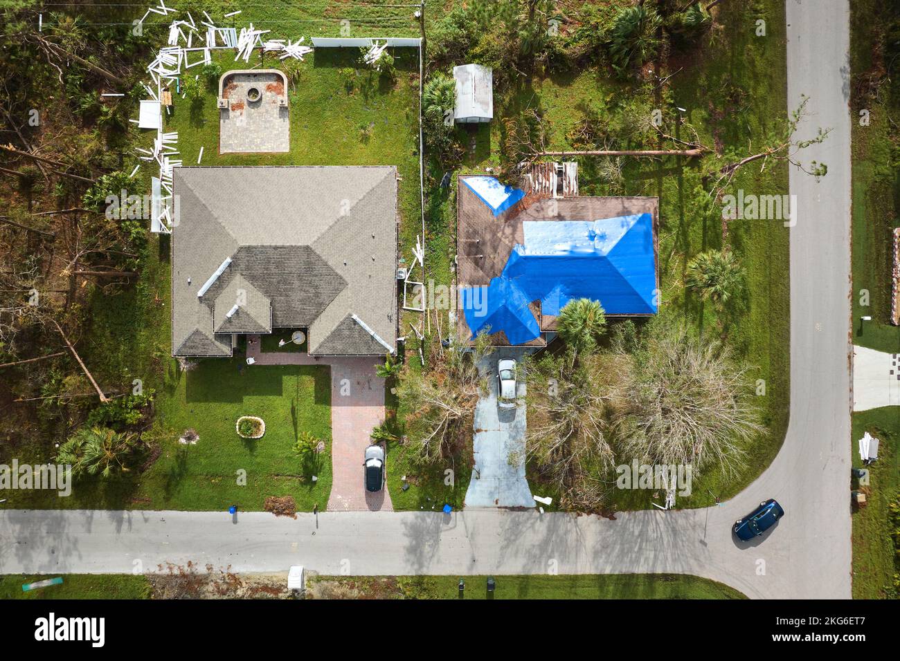 Top view of leaking house roofs covered with protective tarp sheets ...
