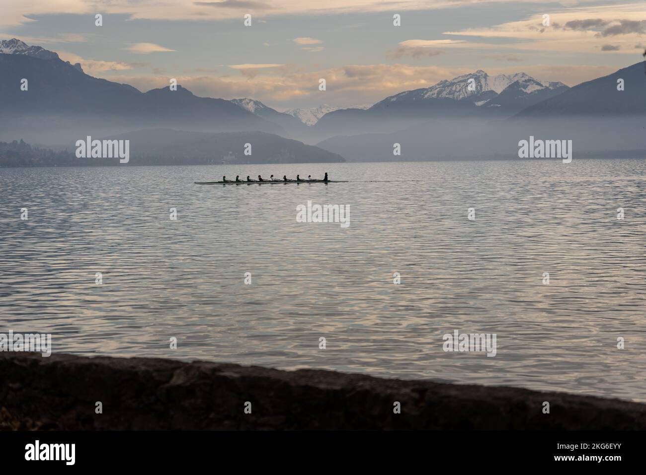 An aerial view of lake surrounded by mountains during sunset Stock ...