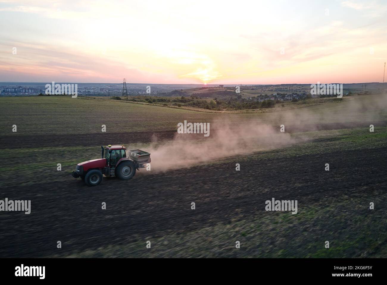 Tractor spraying fertilizers with insecticide herbicide chemicals on ...