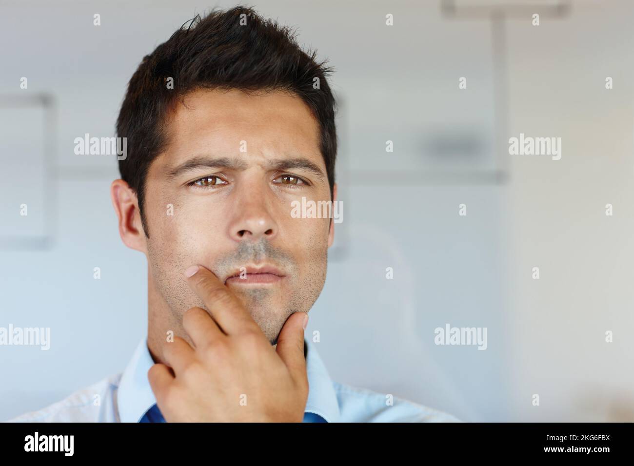 These plans are too see through. a young man looking thoughtfully at a ...