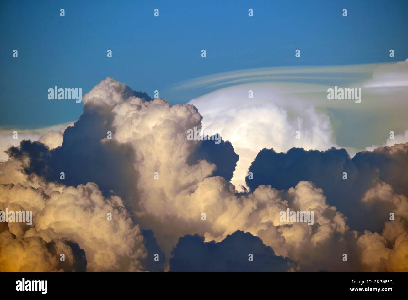 White fluffy cumulonimbus clouds forming before thunderstorm on evening ...