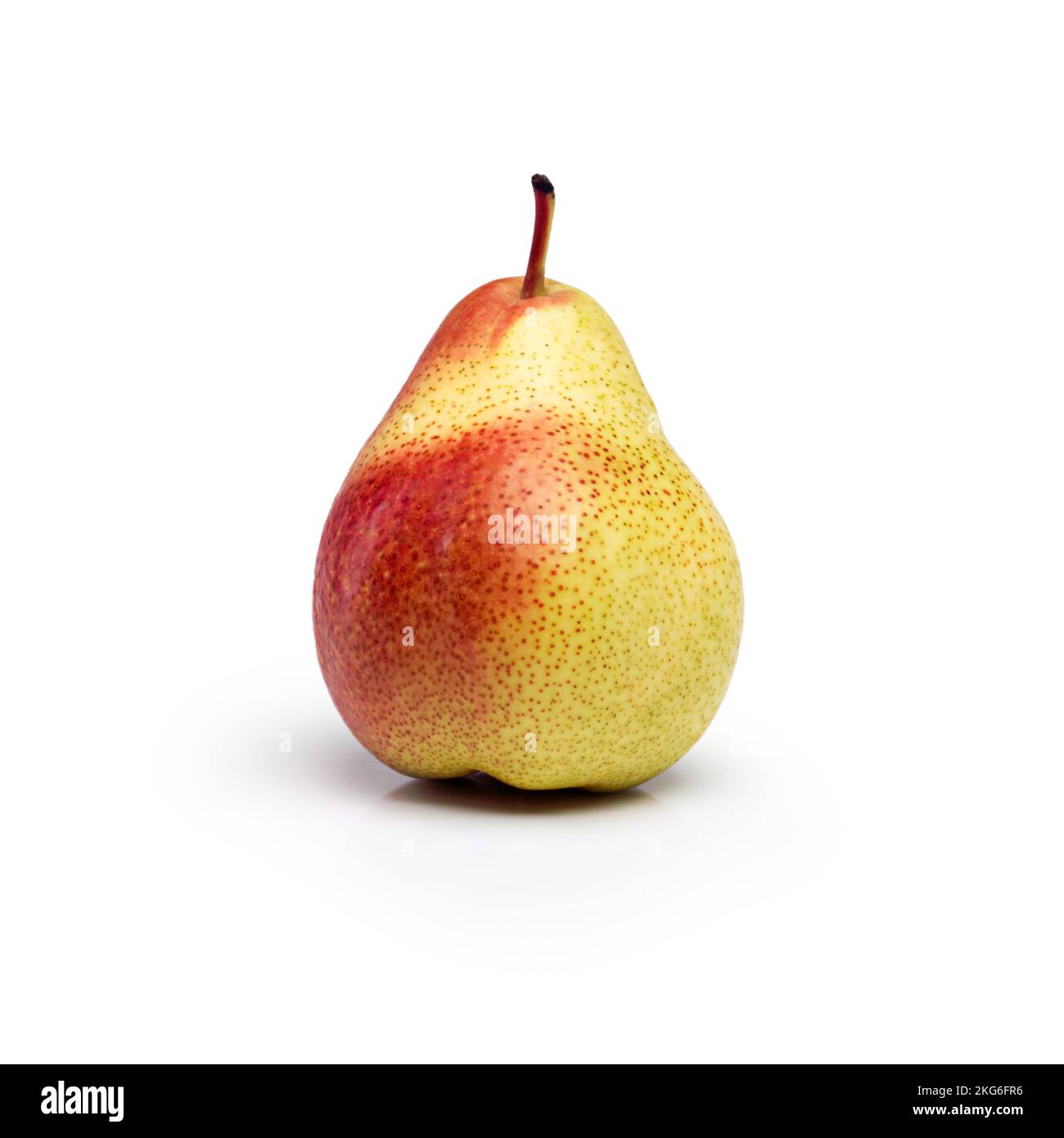 Ready to be munched. Studio shot of a ripe pear against a white ...