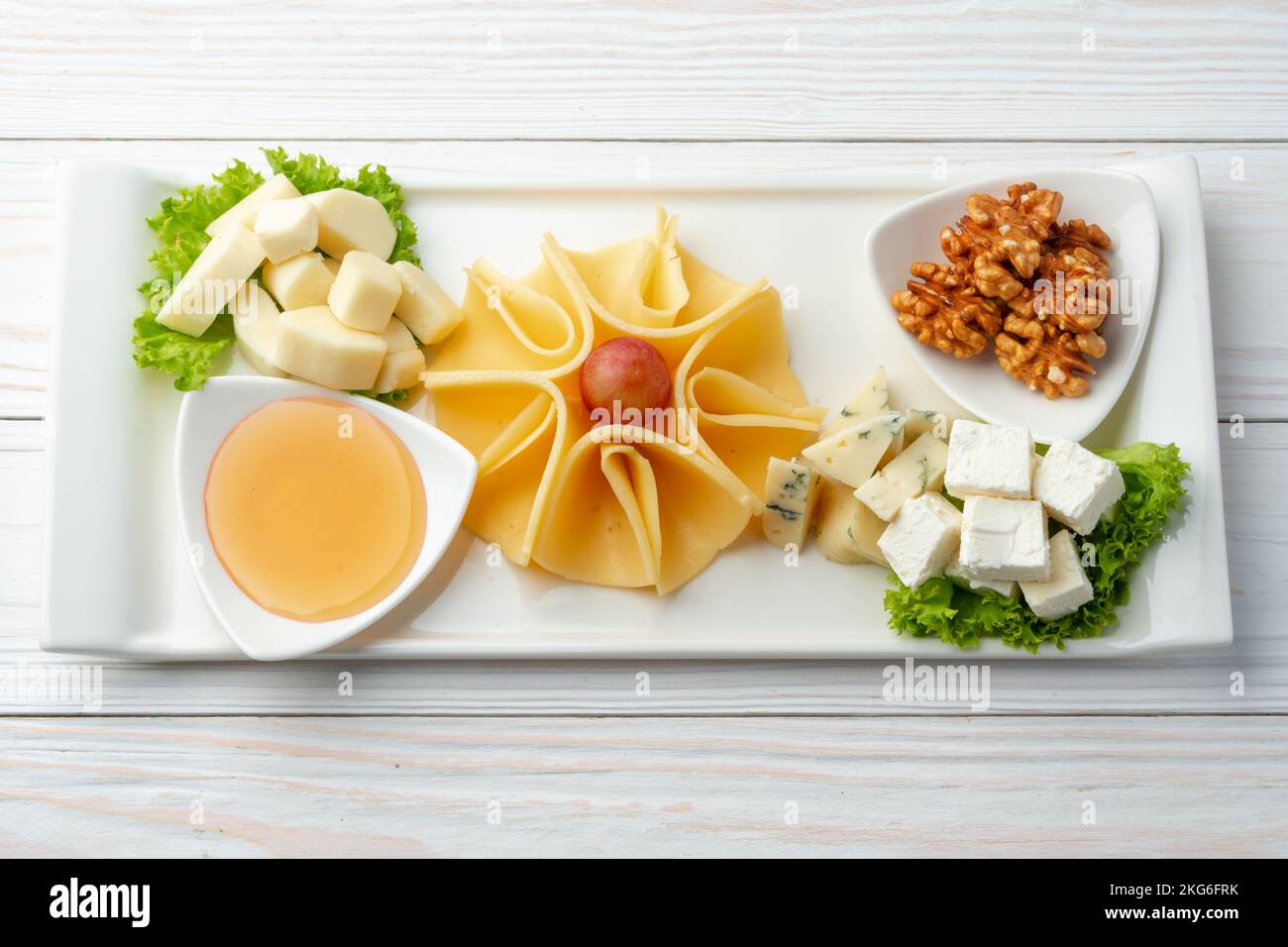 Assortment of cheese on a white plate Stock Photo - Alamy