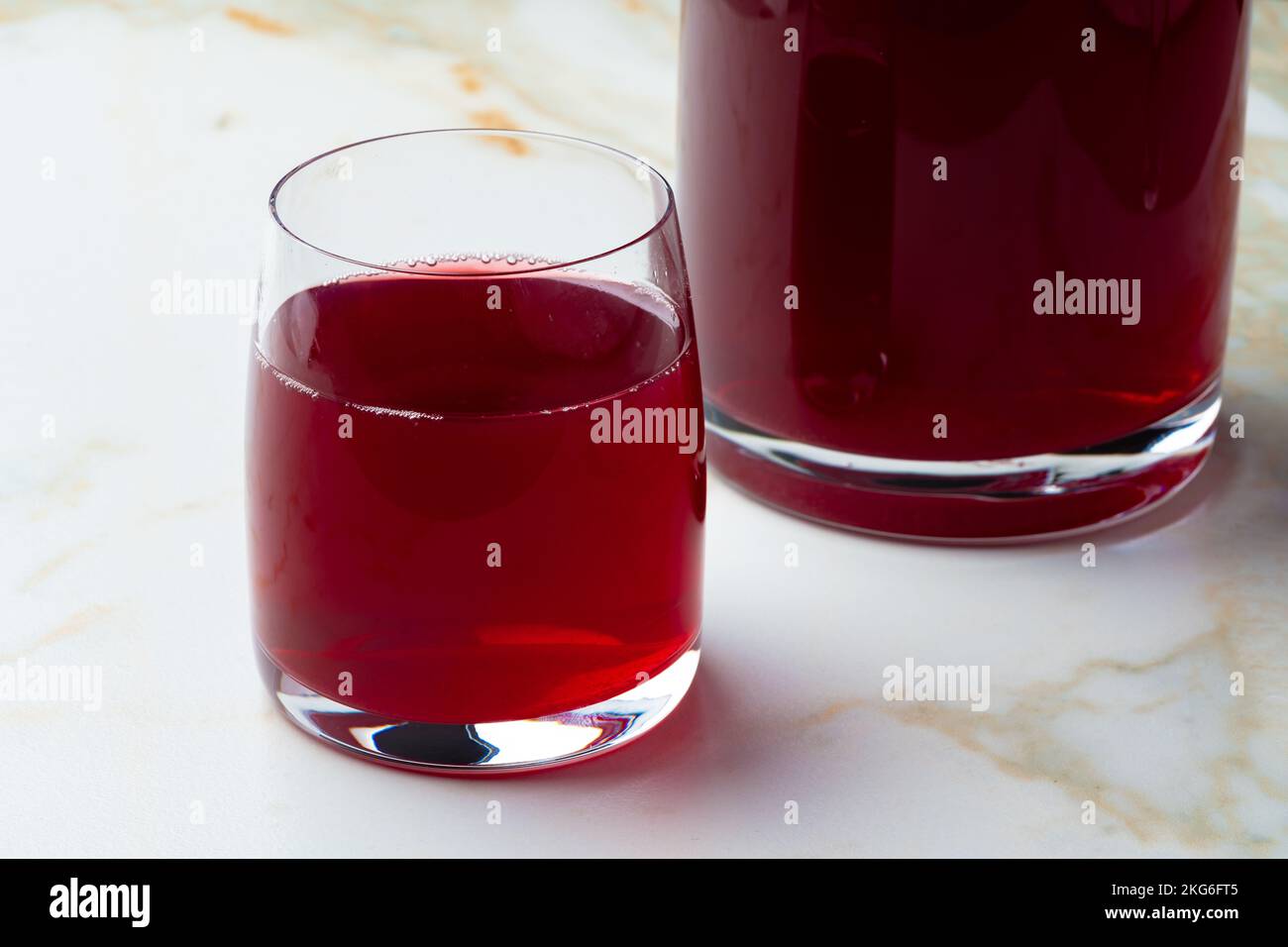 Pitcher and glass of compote on table Stock Photo - Alamy