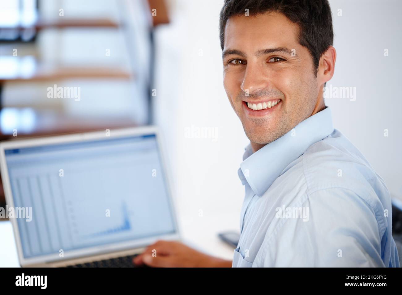 These figures look great. a happy young man working on his computer ...
