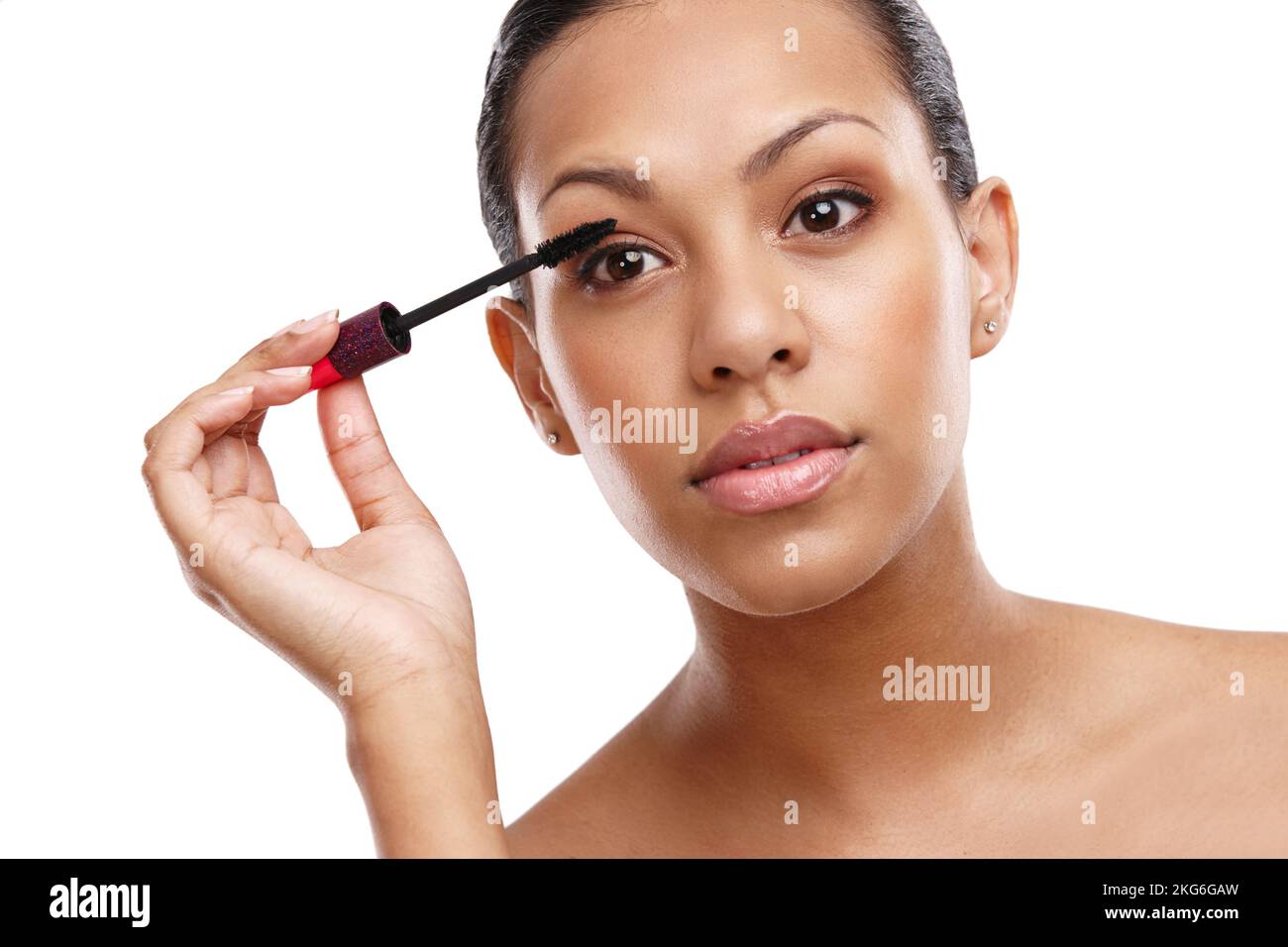 True beauty inside and out. a gorgeous young woman applying mascara in ...