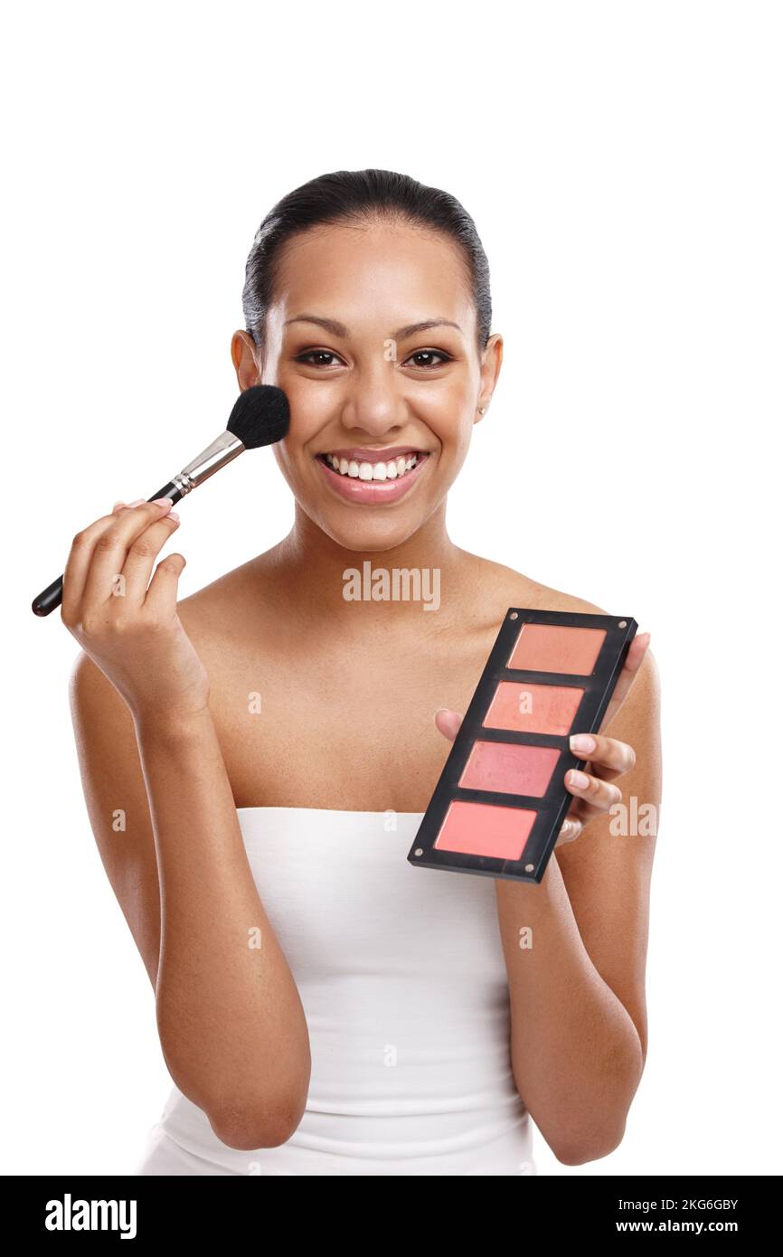 Date night, here I come. a beautiful young woman applying blush to her ...