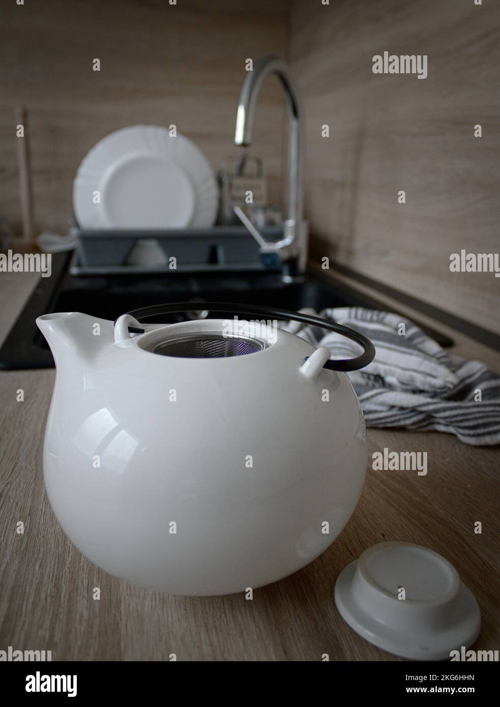 The vertical high-angle view of a teapot on the kitchen counter by the ...