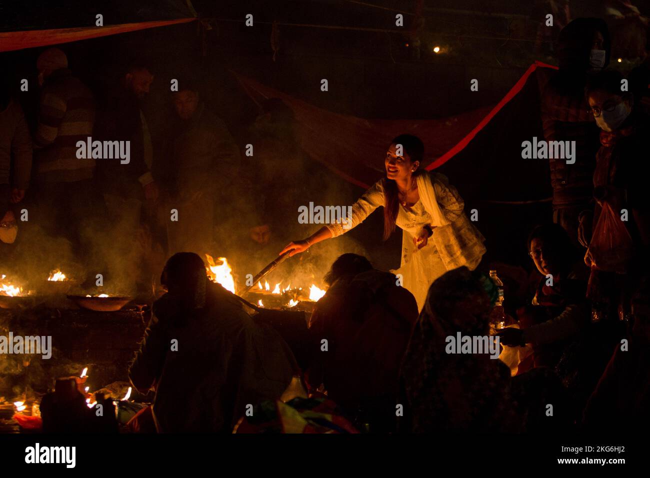 Kathmandu, Nepal. 21st Nov, 2022. A woman lights an oil lamp during the ...
