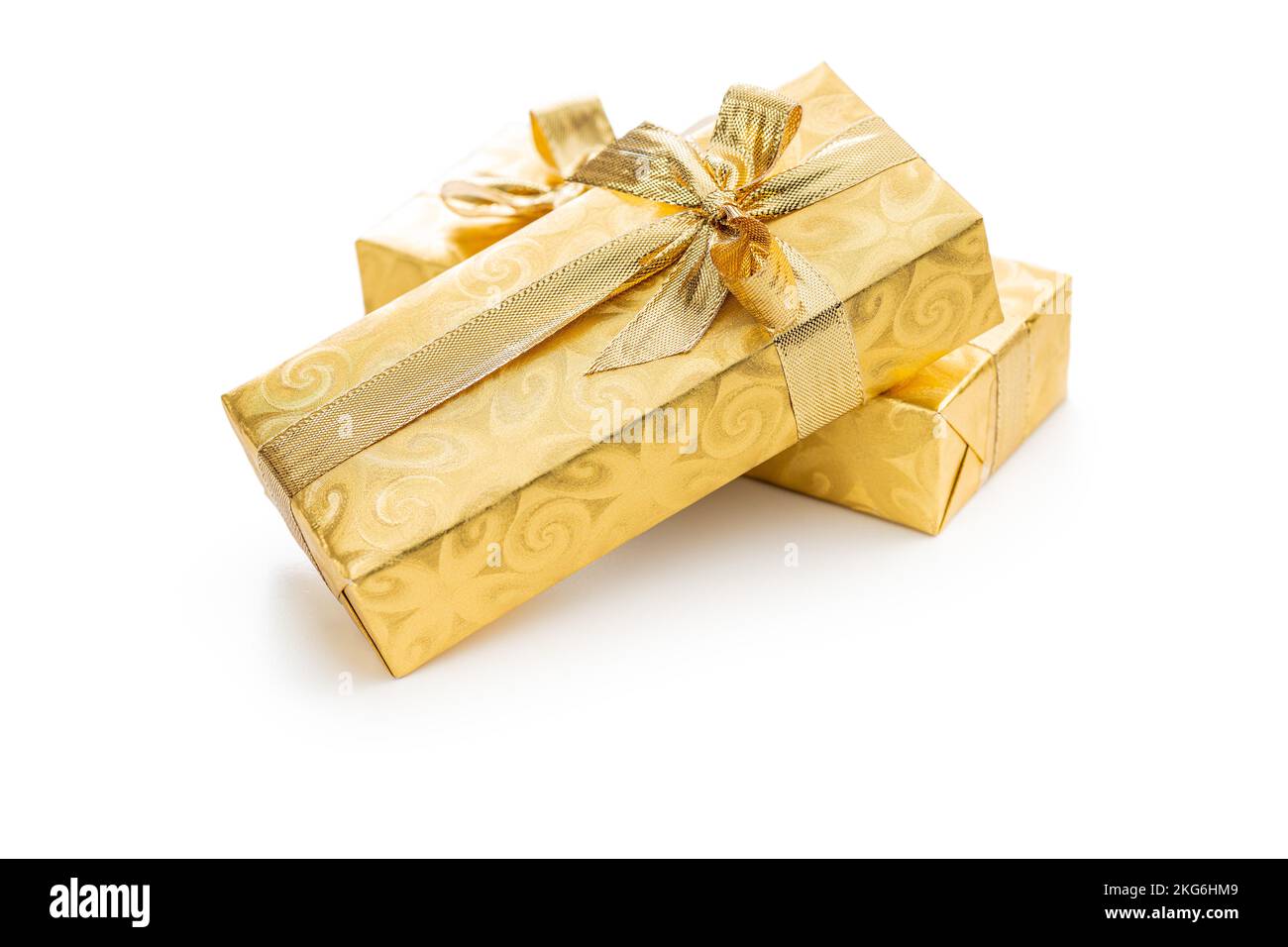 Gift wrapped in gold foil. Christmas present with gold ribbon isolated ...