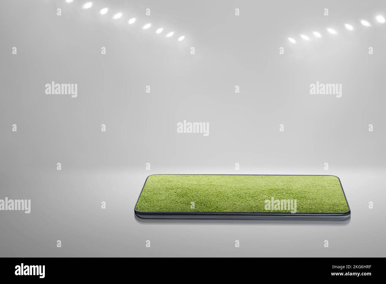Football stadium field on the mobile phone screen with spotlights ...