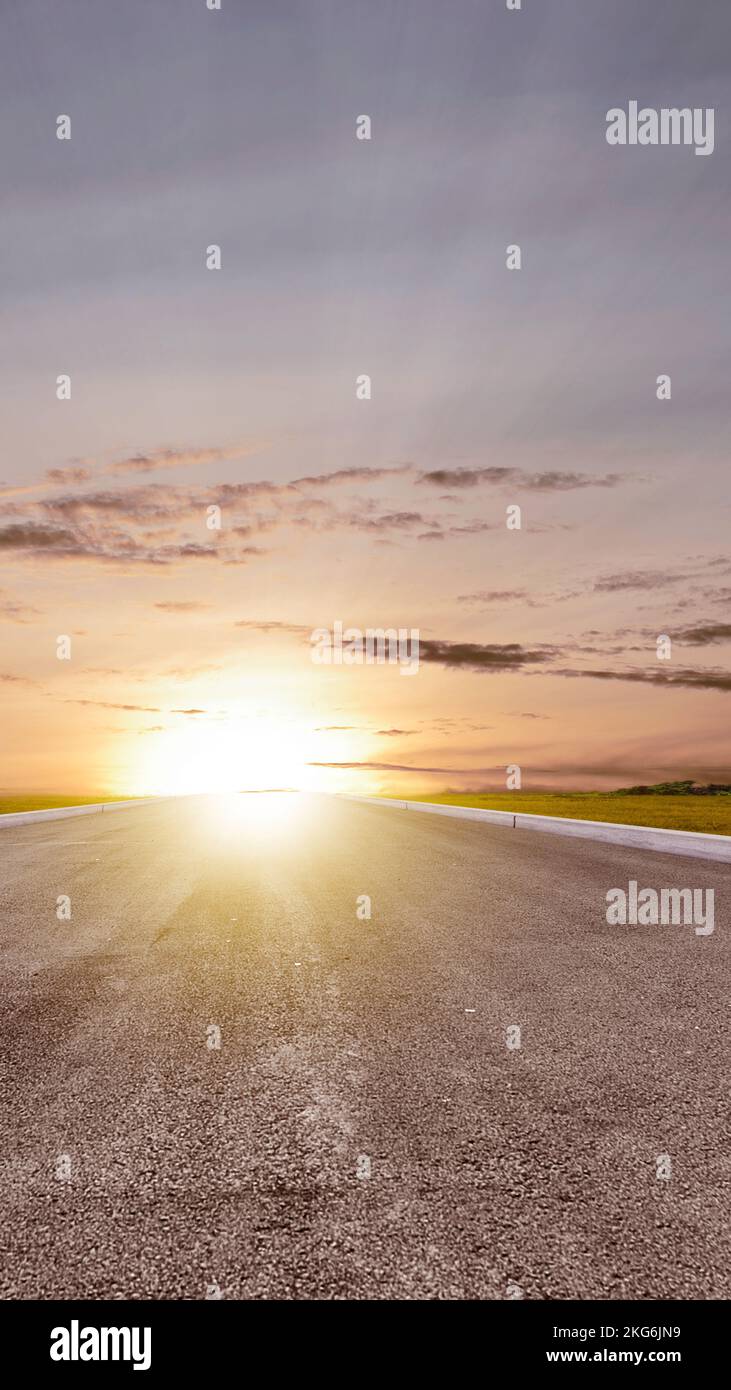 Asphalt road with green grass and sunset sky background Stock Photo - Alamy