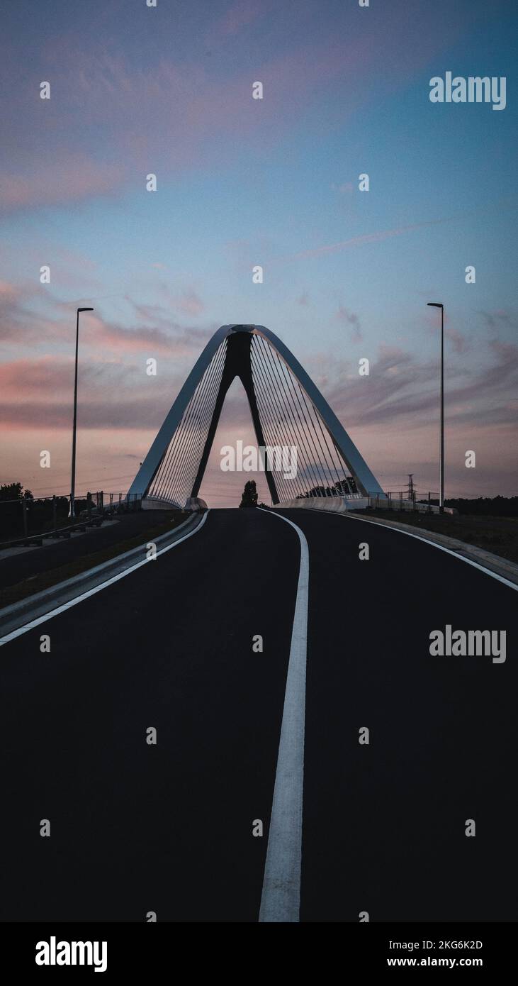 An asphalt highway with an arch bridge Stock Photo - Alamy