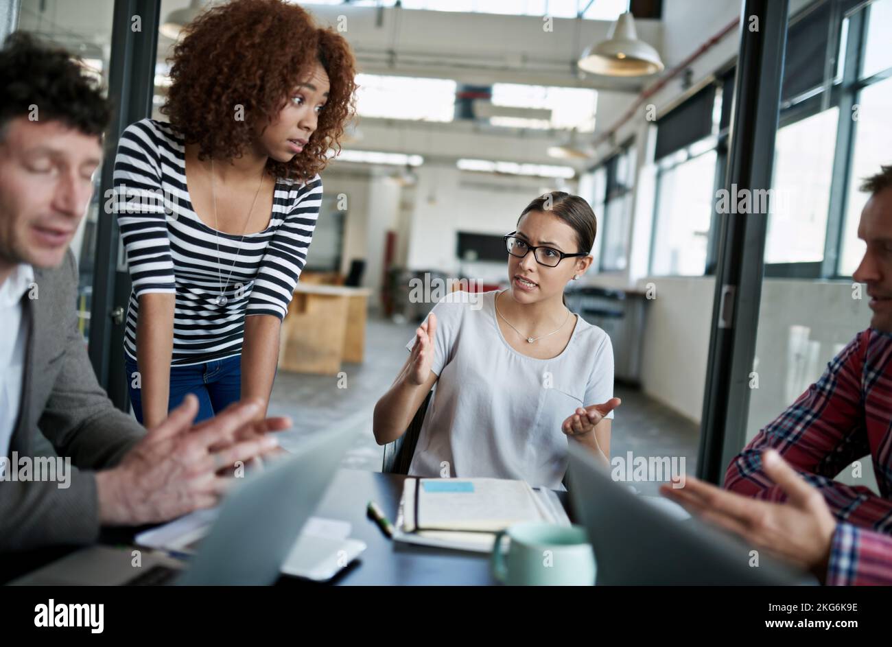 Putting their ideas on the table. office workers talking in a meeting ...