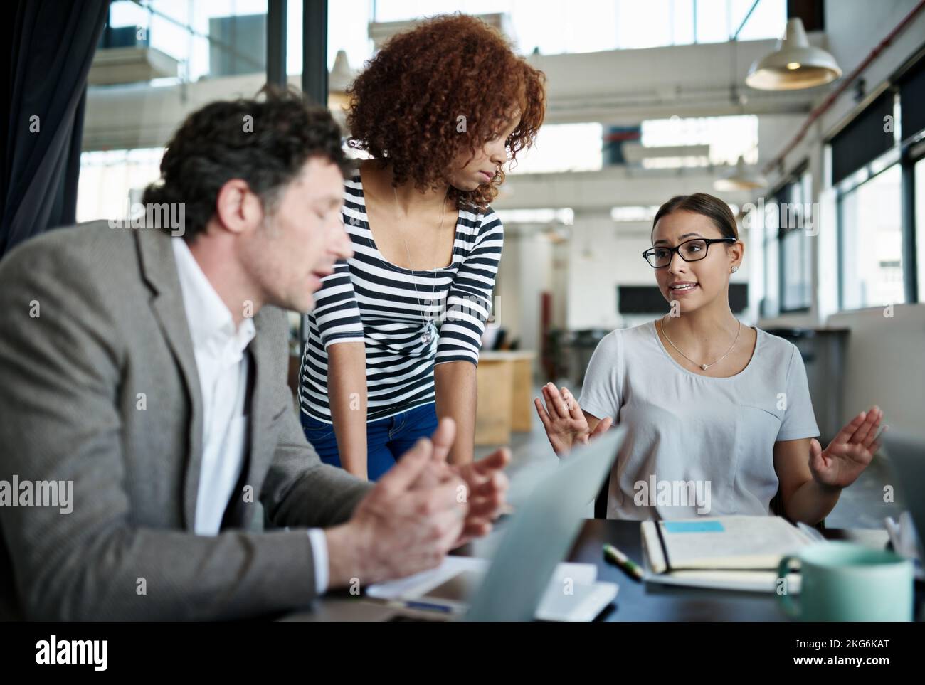 Success is earned. office workers talking in a meeting in an office ...