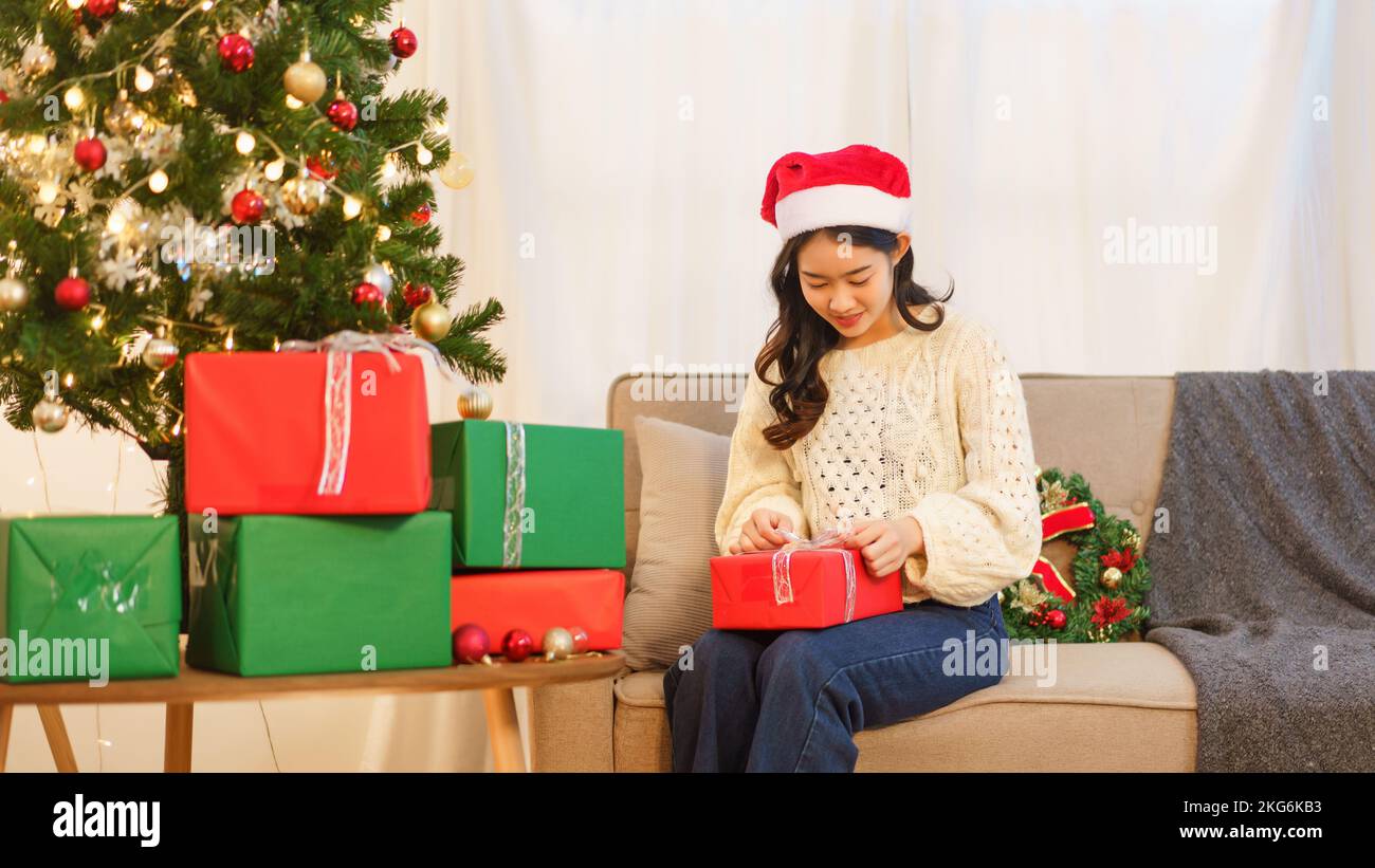 Christmas celebration concept, Young asian woman sitting on the couch ...