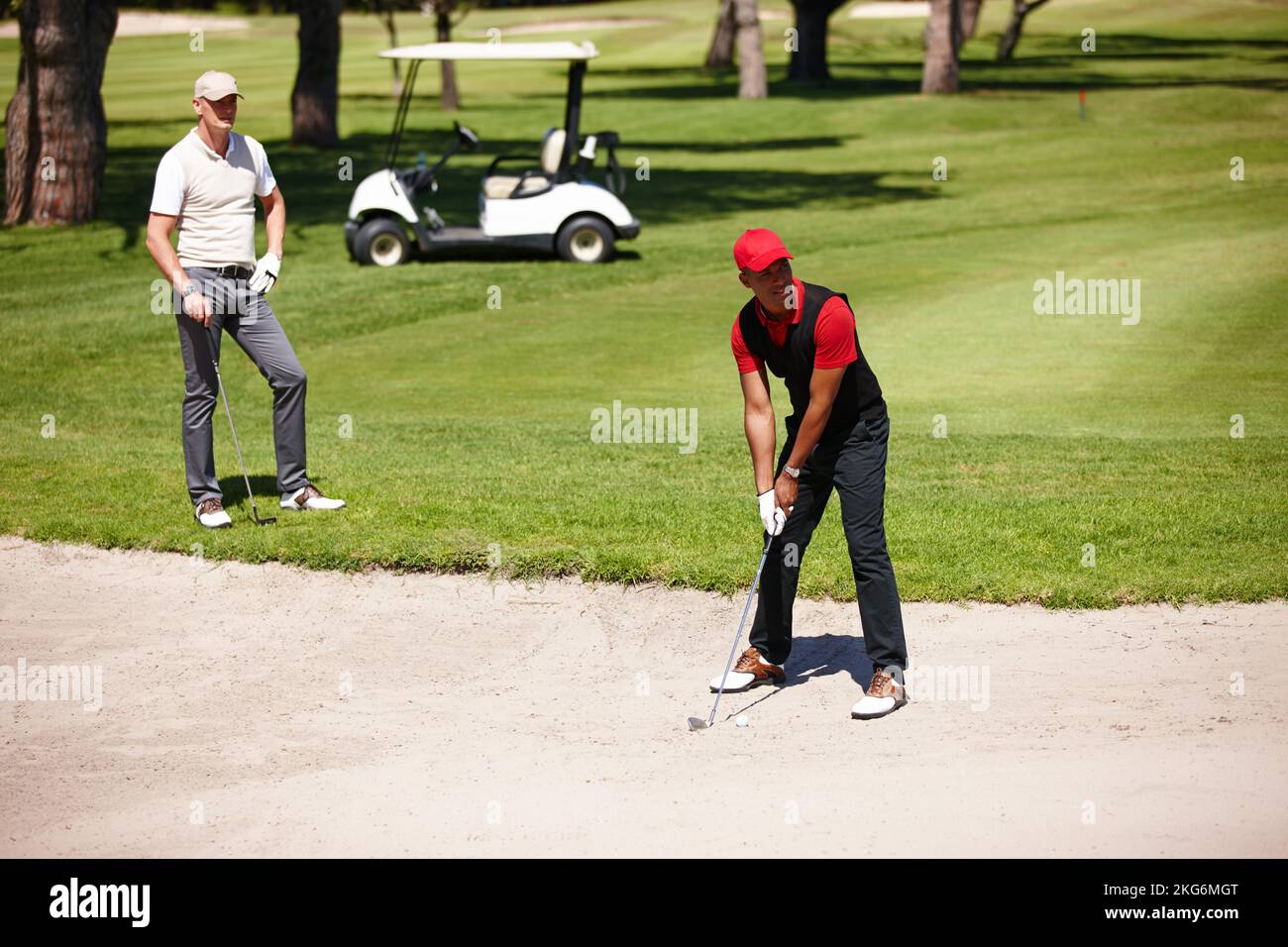 Planning the perfect shot. two handsome men playing a game of golf ...