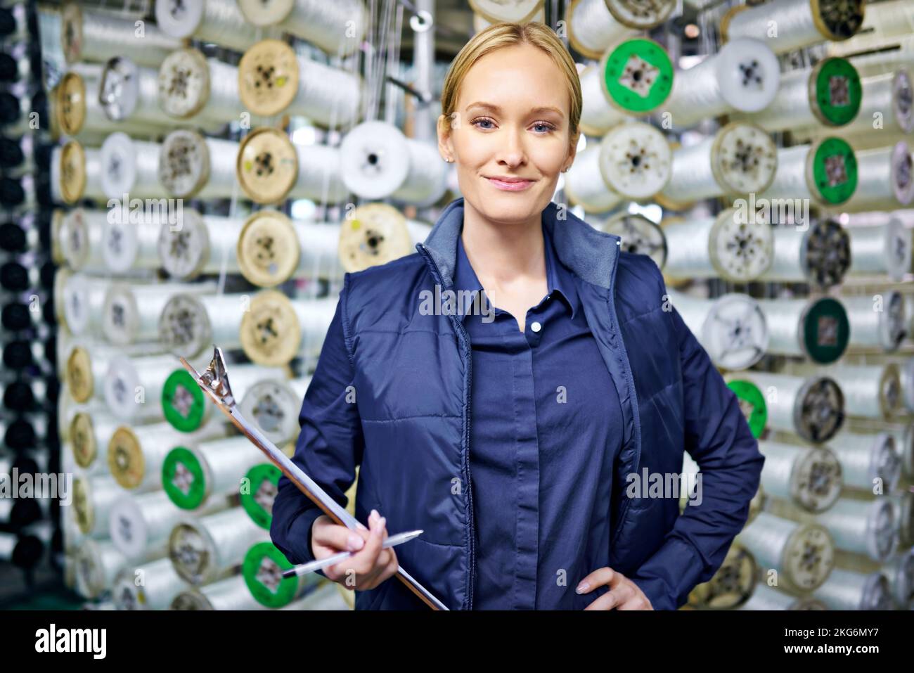 If its made, we make it. Portrait of an attractive young female worker ...