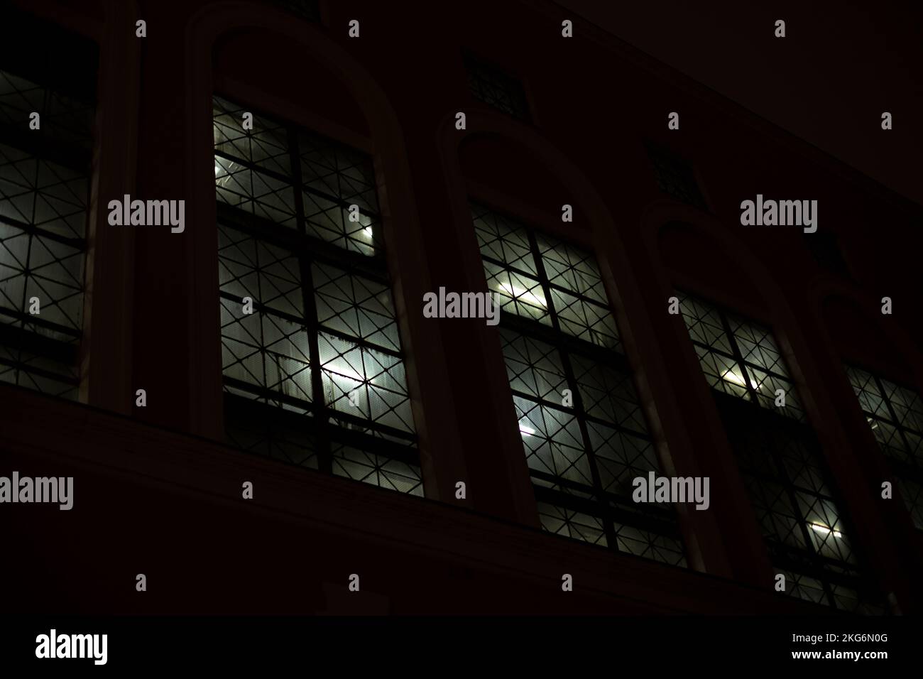 Windows at night. Light in windows in evening. Building outside in dark ...