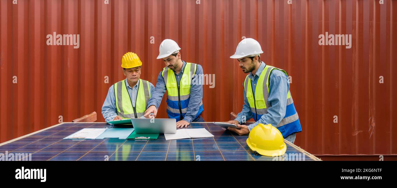 Project manager pointing at shipping schedule on laptop computer ...