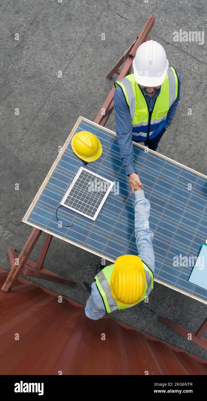 Young engineer in hardhat and safety vest shake hands with project ...