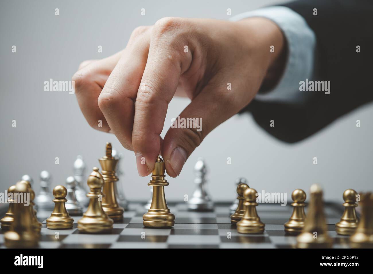 hand of businessman moving chess figure in competition success play ...