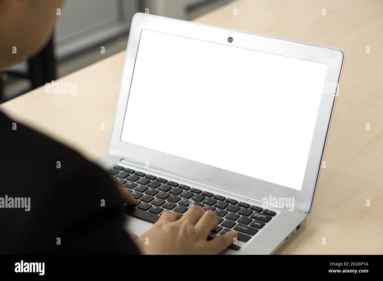 Back view of businessman in suit sit at desk in office typing on laptop ...