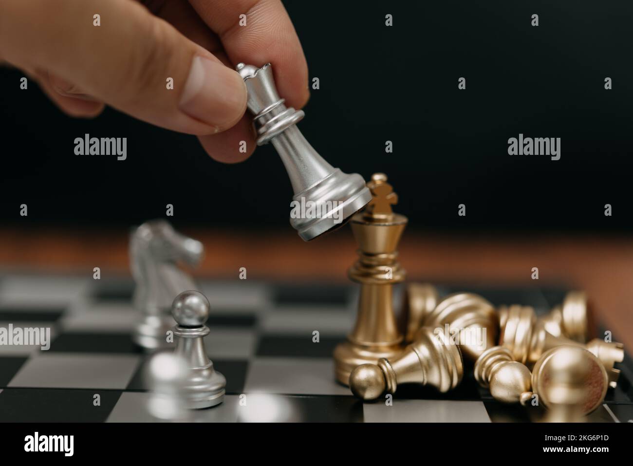 hand of businessman moving chess figure in competition success play ...