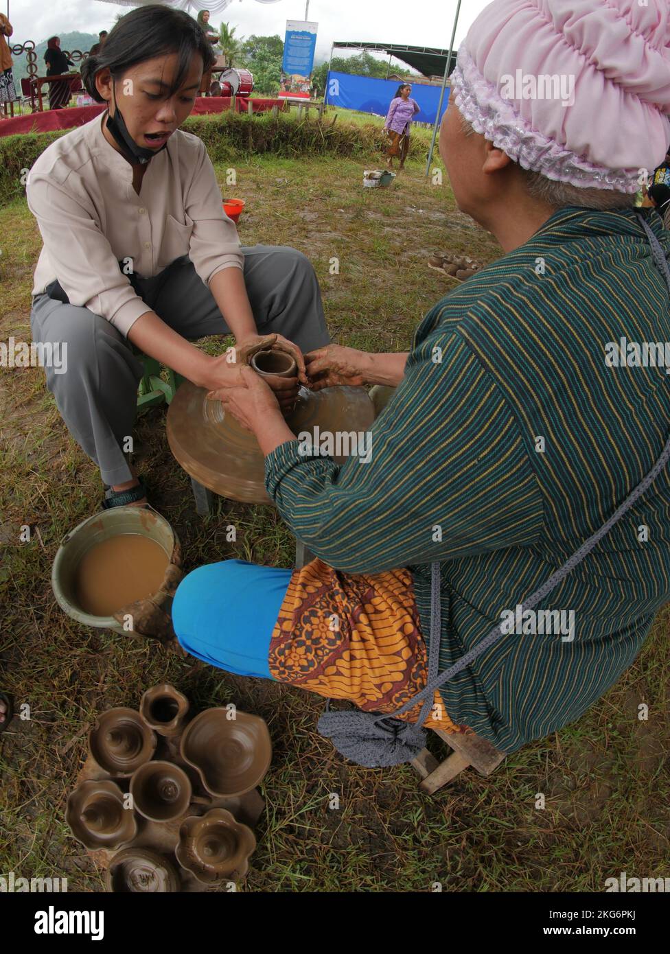 a woman learns to make pottery traditionally from clay Stock Photo - Alamy