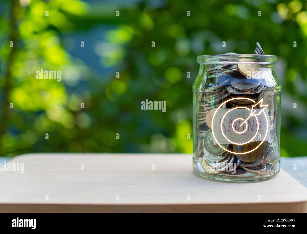 Coins in glass bottles on nature background. The concept of savings and ...