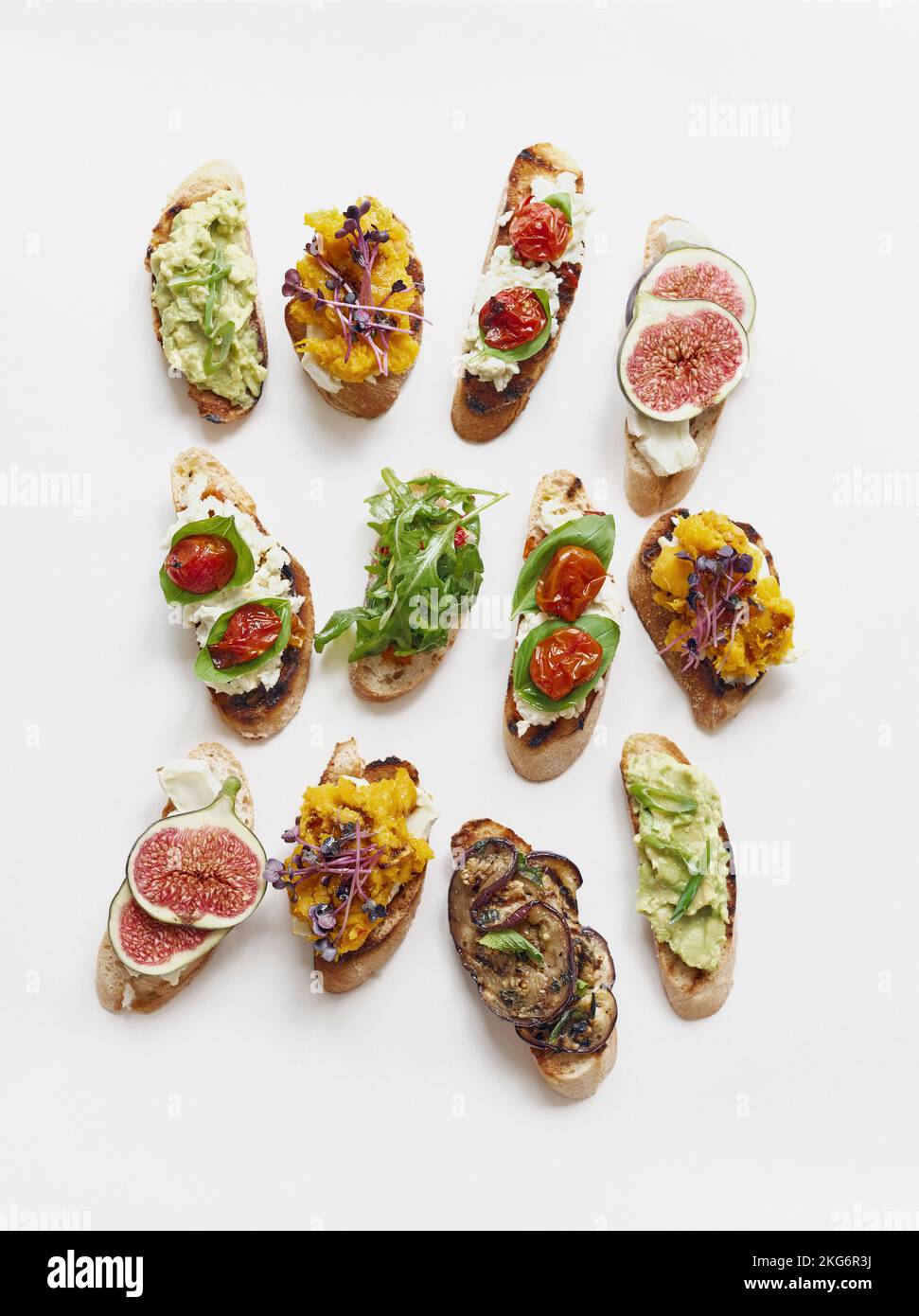 Still life variety fruit and vegetable toast appetizers on white ...