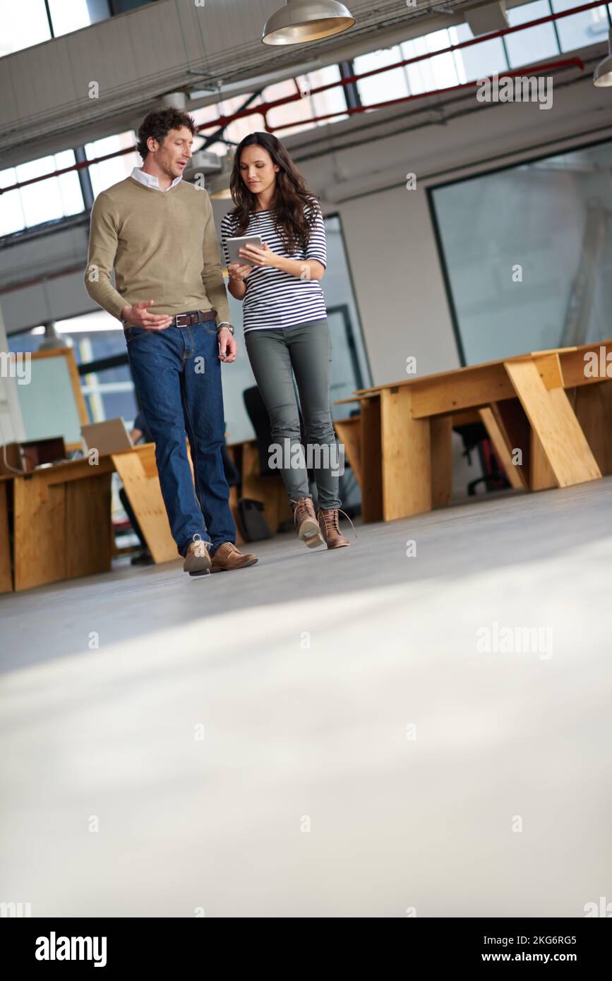 Strategy planning on the go. Male and female colleagues talking and ...